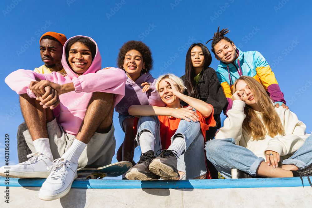 Multiracial group of young friends bonding outdoors Stock Photo | Adobe ...