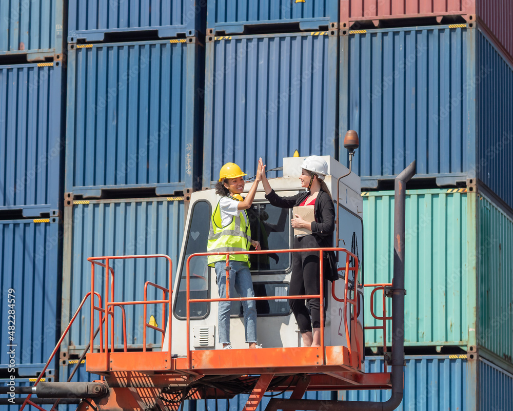 Female African American foreman and industrial engineer stay on lifting ...