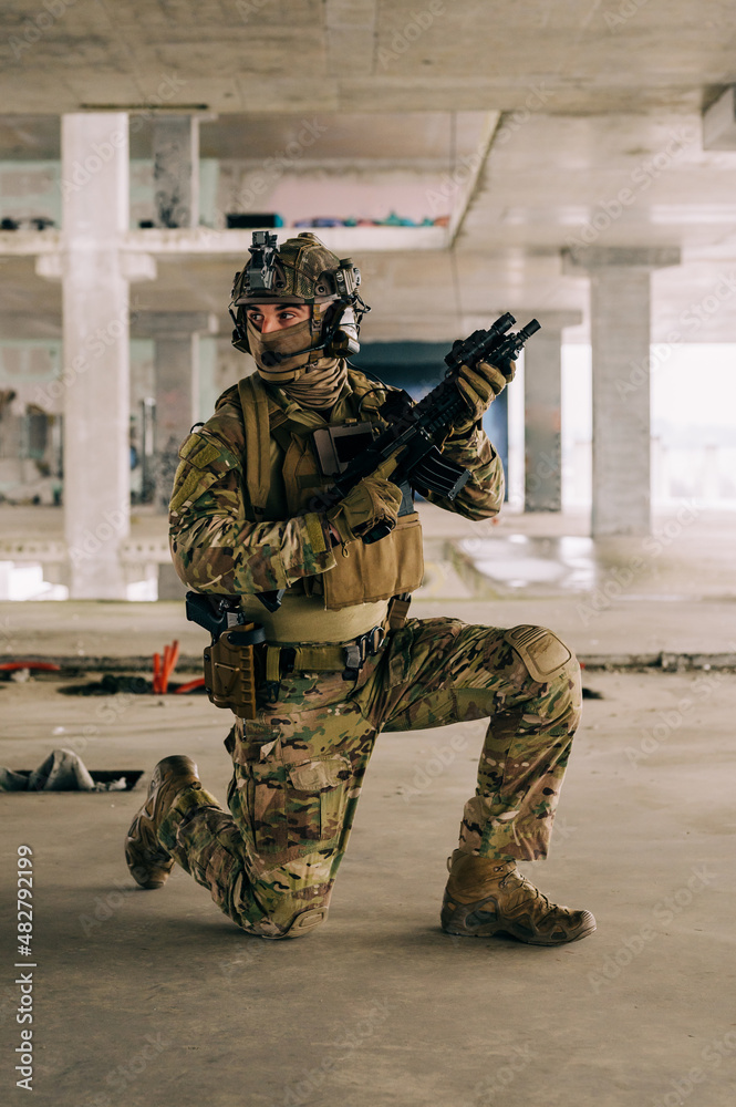 Special forces operator wearing Multicam uniform and his assault rifle ...