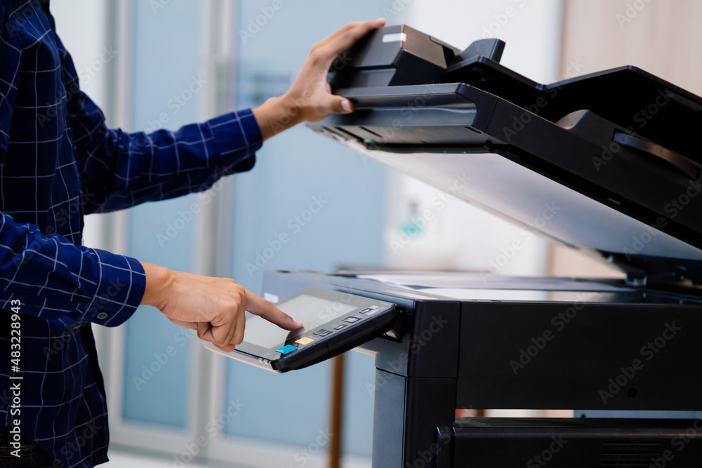 Businessmen press button on the panel for using photocopier or printer ...