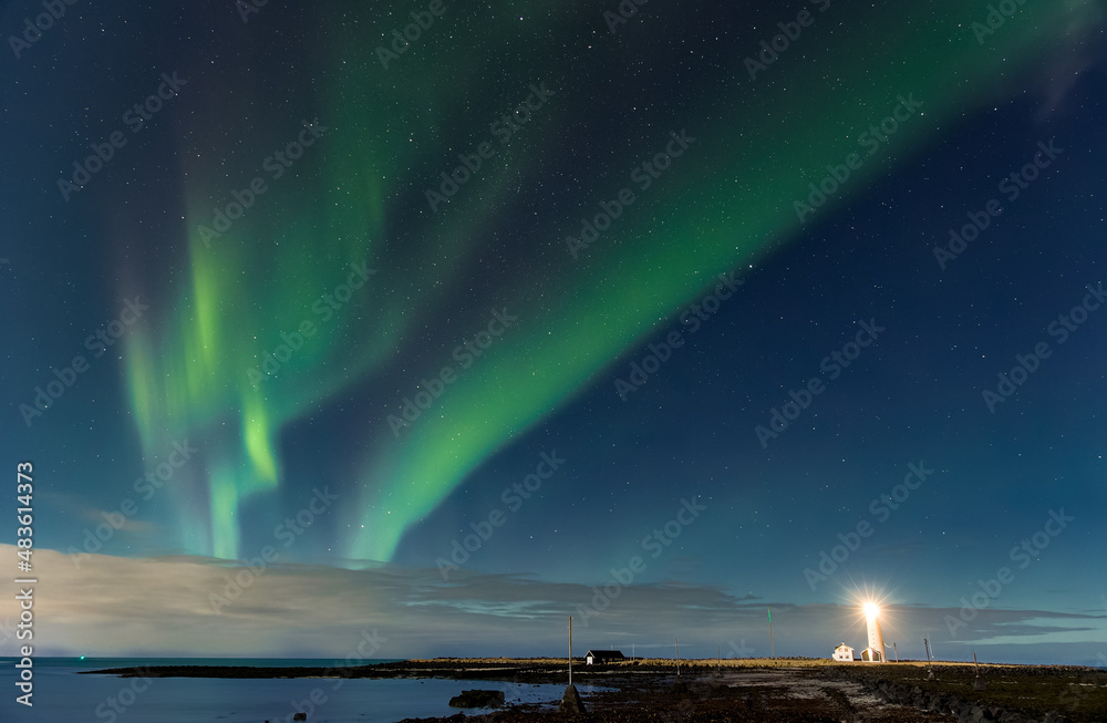 Aurora Borealis displaying above Grotta Island lighthouse in the city ...