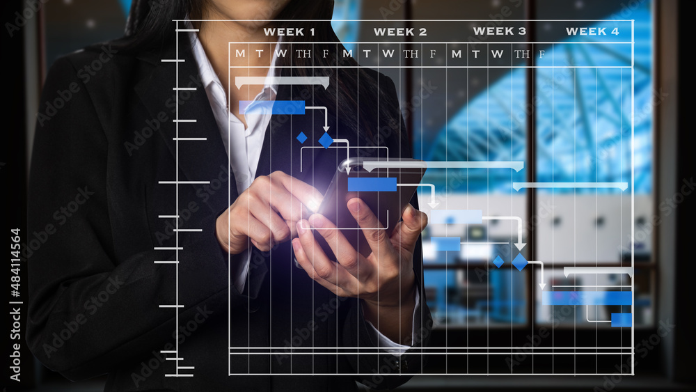 Project manager working and update tasks with milestones progress ...