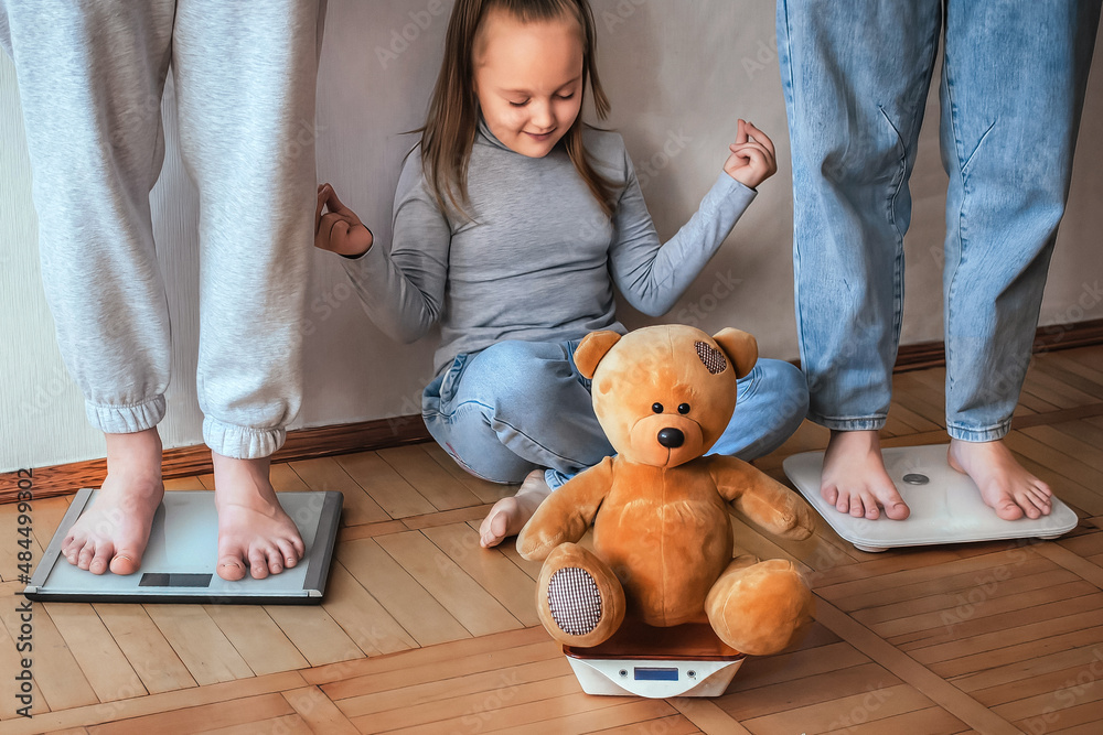 Photo Stock The family is weighed at home, two young women stand on the ...
