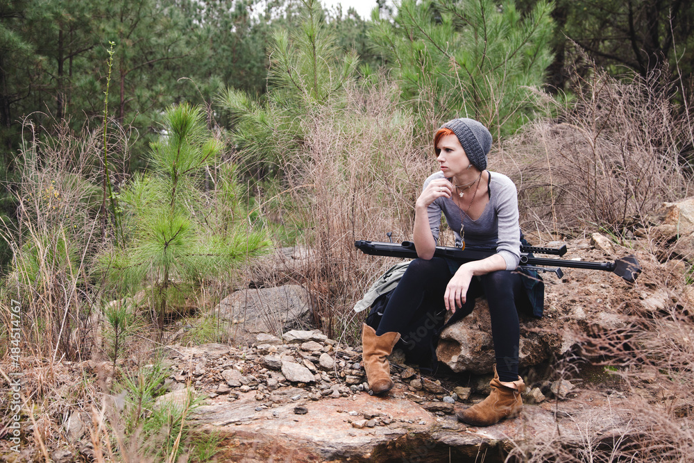 Beautiful and intense redhead sniper woman in profile with .50 caliber ...