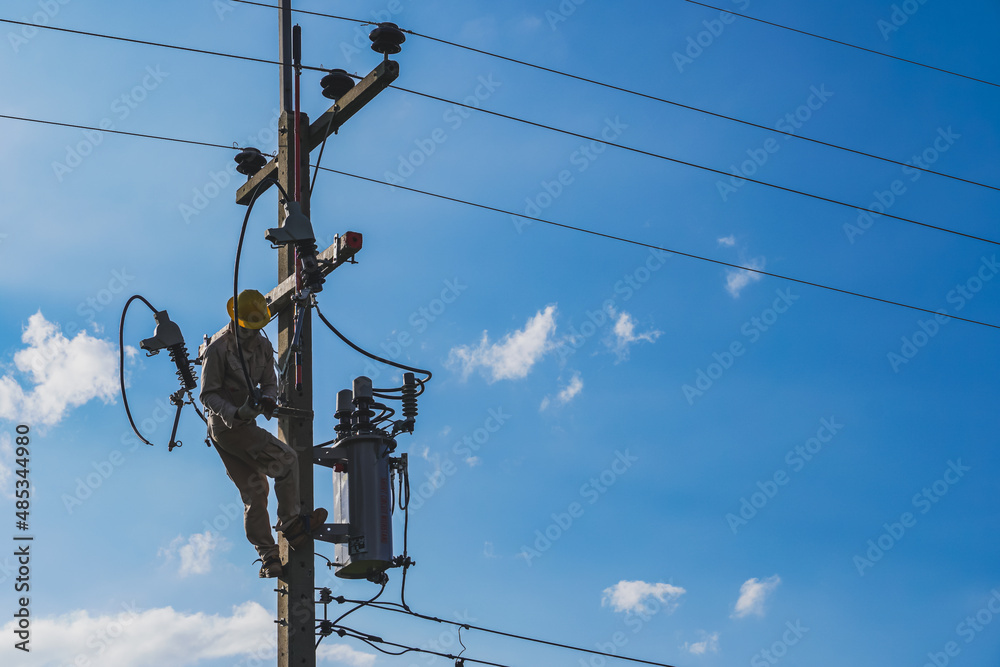 The silhouette of power lineman replacing a transformer and hotline ...