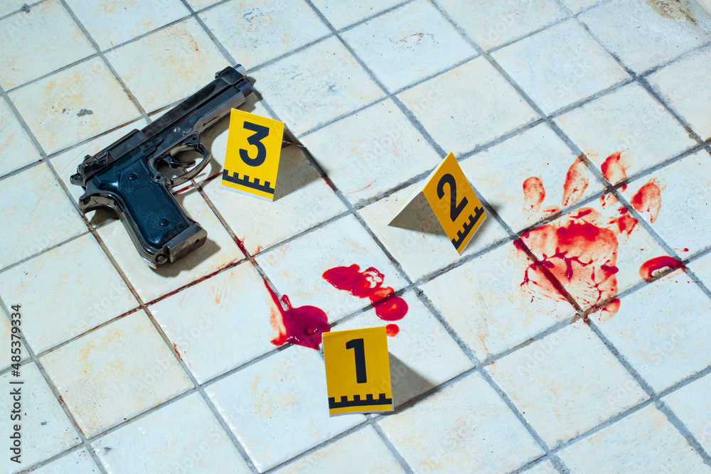 Crime scene investigation with a gun, blood stains, hand print and ...