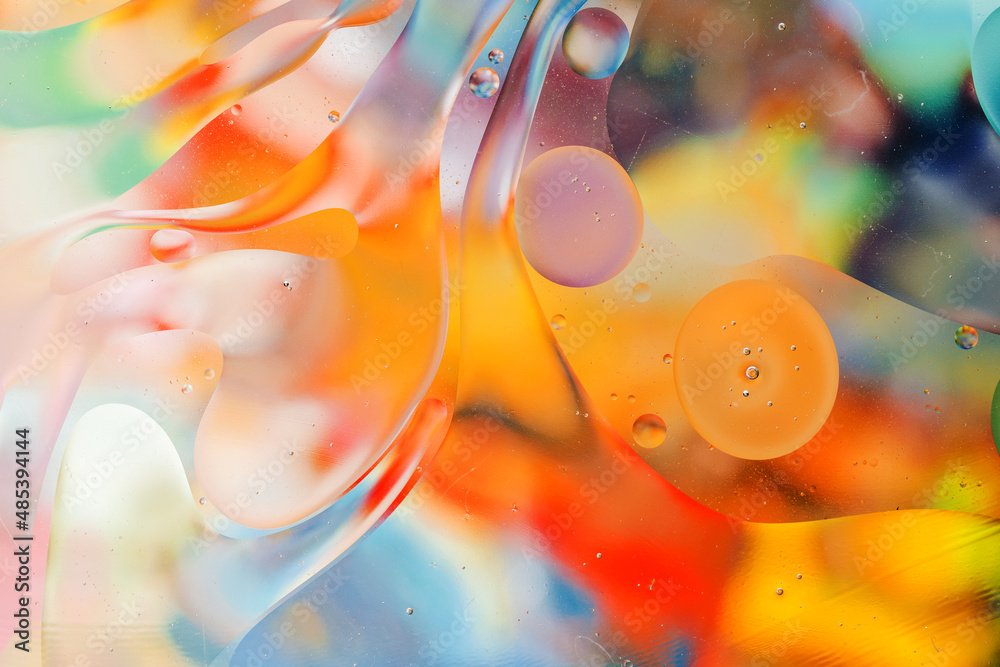 Close-up of the movement of oil droplets on the water surface. Colorful ...