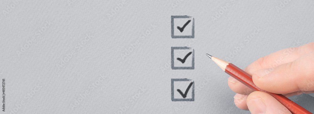hand with pencil writing check mark on Checklist. Cropped Hand Marking ...