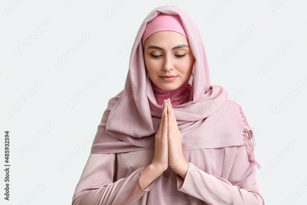 Muslim woman praying on white background Stock Photo | Adobe Stock