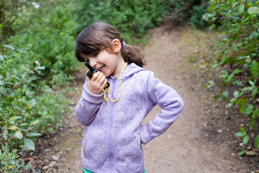 Little girl playing with walkie talkies outdoors Stock Photo | Adobe Stock