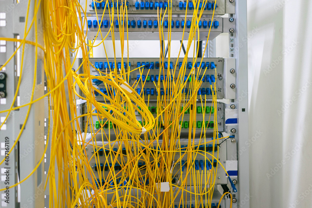 Lots of fiber optic internet cables connected to the ODF panel. Yellow ...