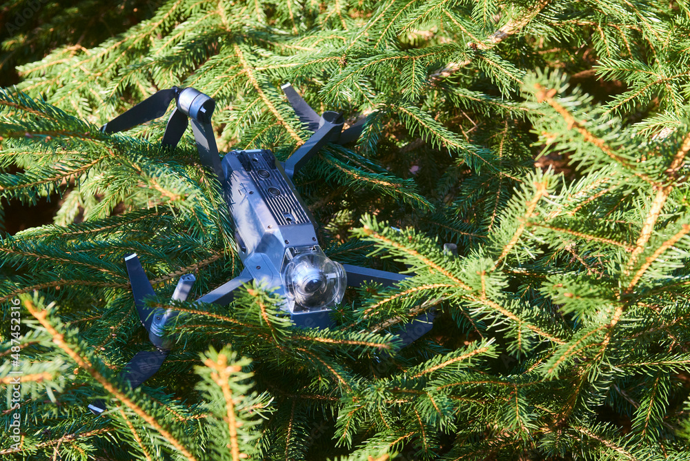 Drone quadcopter accident scene. UAV Quadrocopter crashed on tree in ...