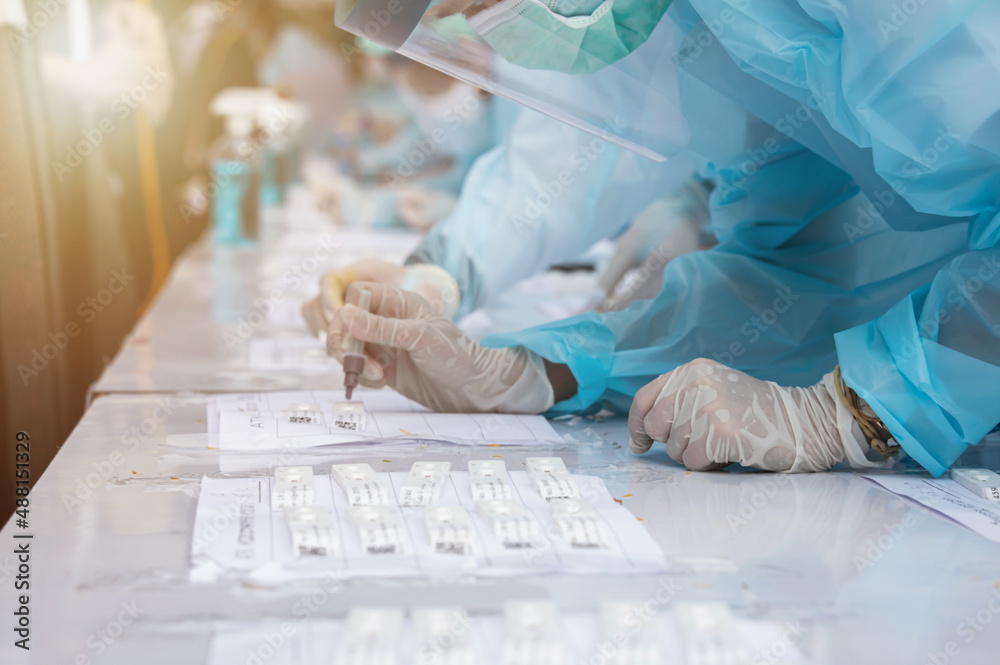 blur background of group doctors wearing anti-virus clothing testing ...
