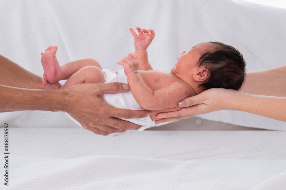 Asian little newborn baby sleep in the hands of parents protected and ...