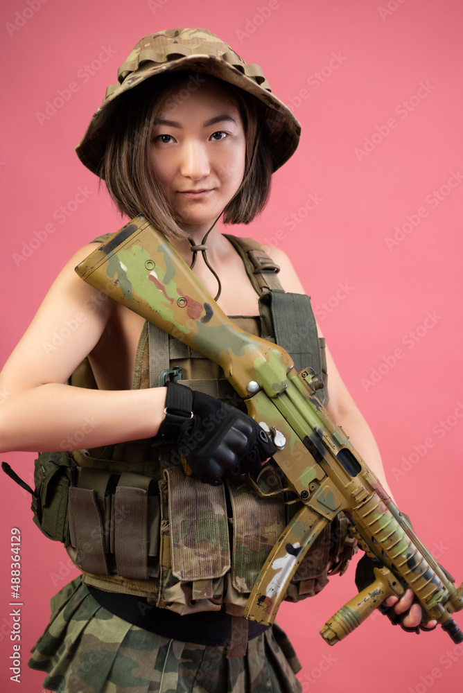 Photo Stock sexy Asian woman in military clothes with an automatic ...
