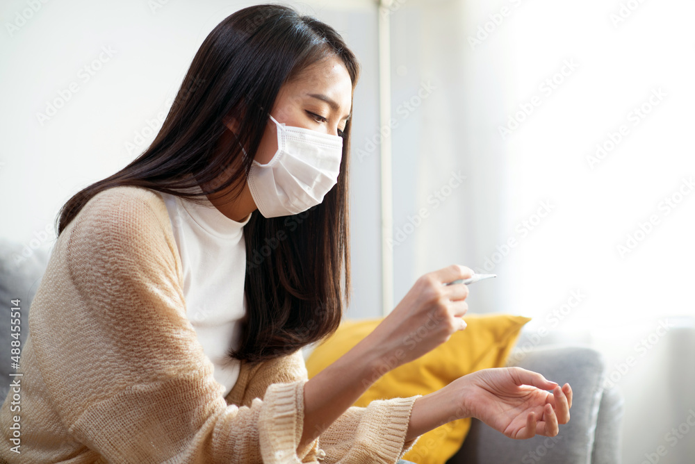 Attractive Asian teenage girls use a temperature measuring device Shows symptoms of fever ...