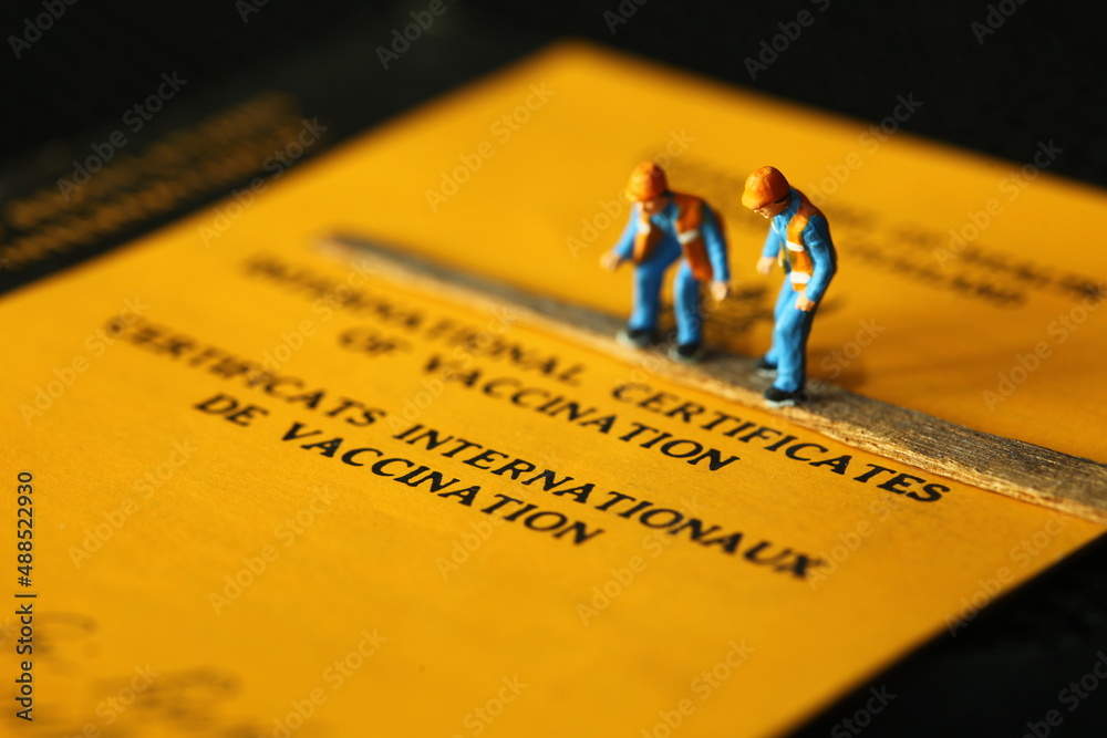 Miniature model figure and passport scene represent vaccine passport ...