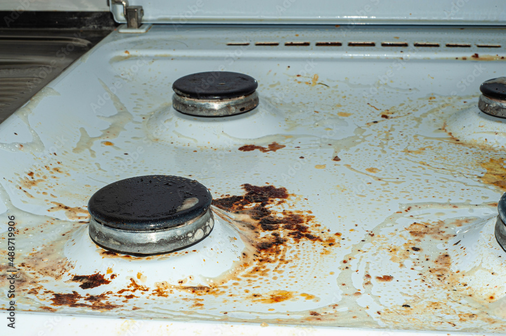 Dirty stove with food leftovers. Unclean gas kitchen cooktop with ...