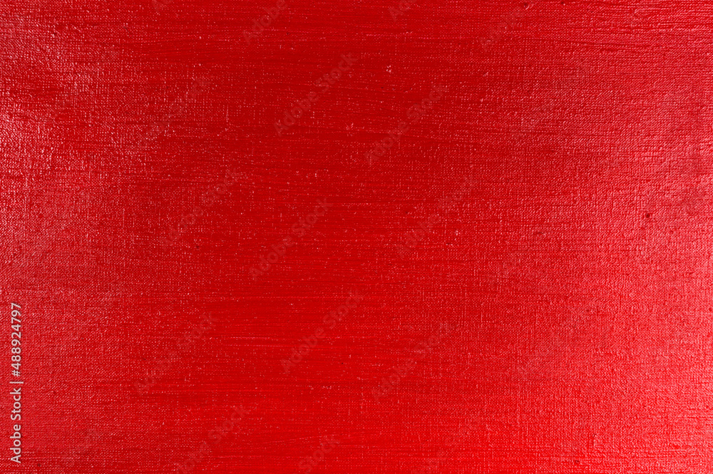 bright red background: thick acrylic paint in an uneven layer on a flat ...