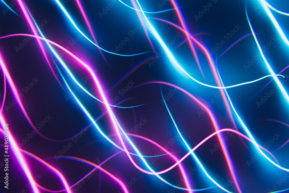 ภาพถ่าย Stock Neon blue and pink led lines on a dark night background ...