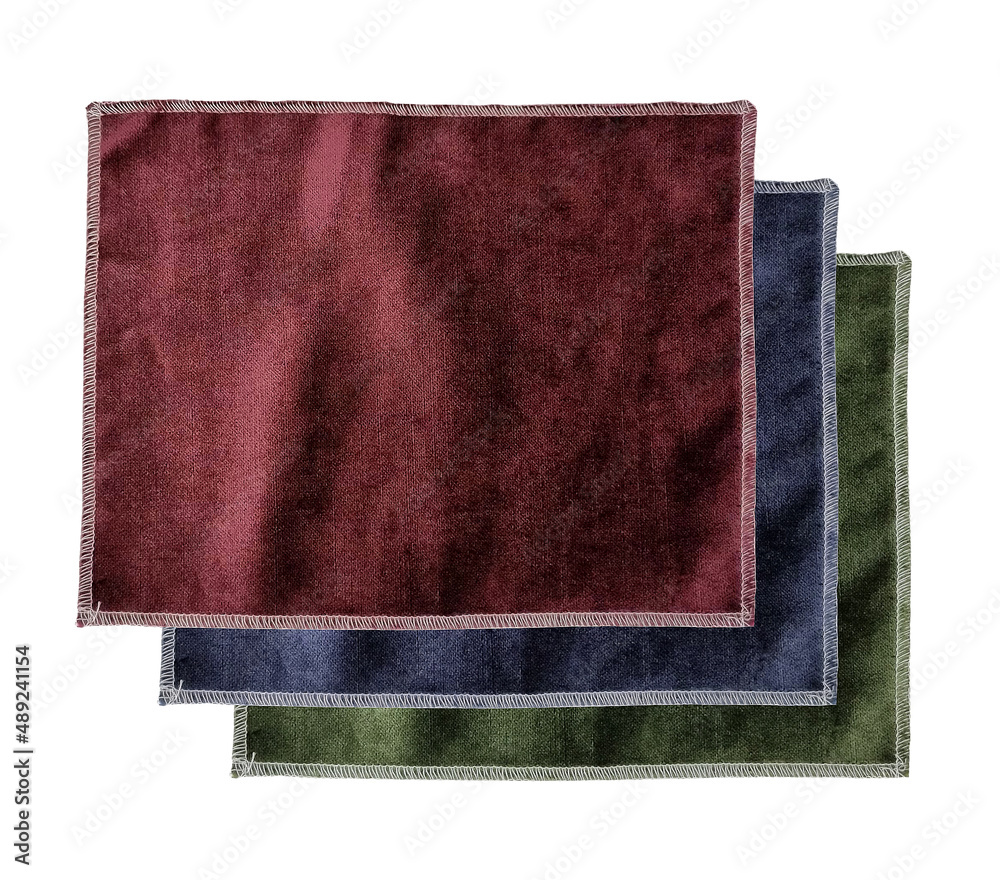 stacked of velvet fabric samples in red, blue and green color isolated ...