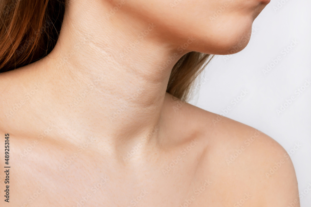 Сropped shot of a young woman with lines on the neck isolated on a ...