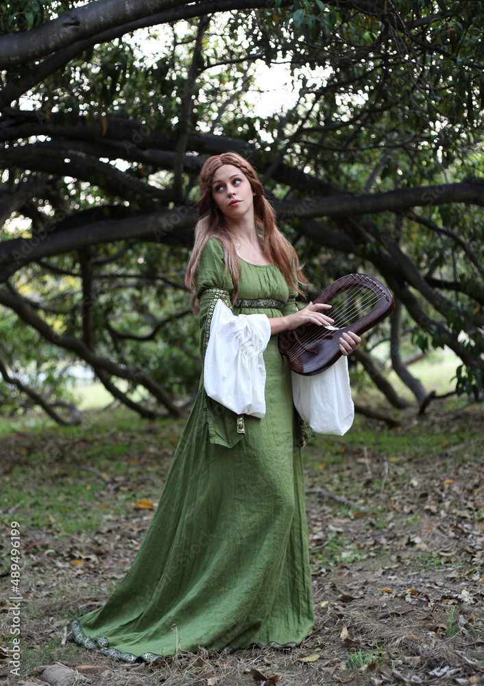 Full length portrait of blondewoman wearing a beautiful green medieval ...