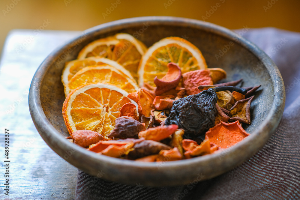 Dried fruits in an old clay plate on a wooden table. Compote. Uzvar ...