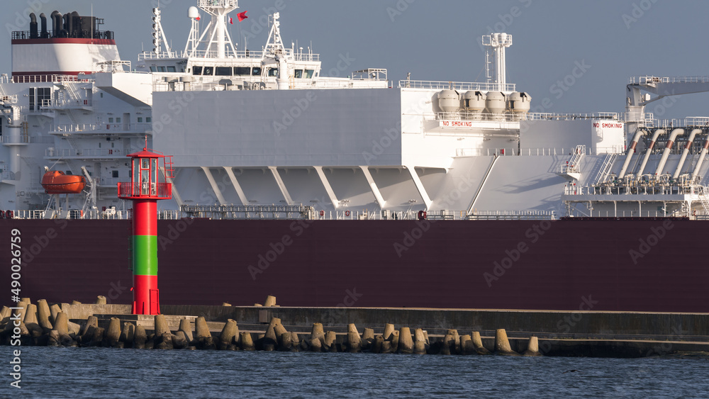 NAVIGATION SIGN AND LNG TANKER - Ship with gas supply goes to the port ...