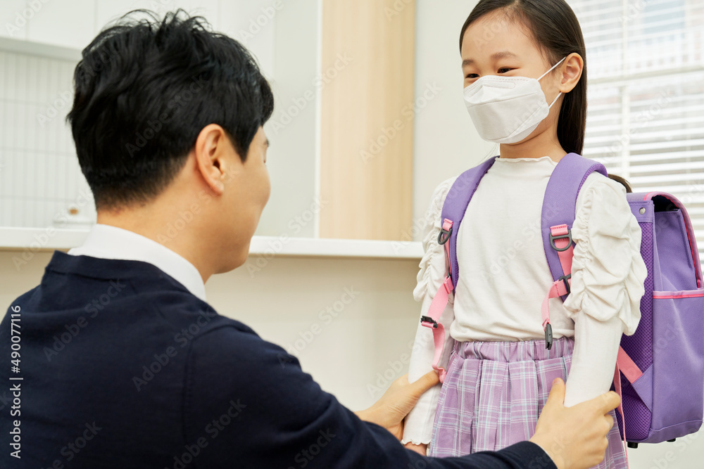 Elementary school children wearing school uniforms and masks and their ...