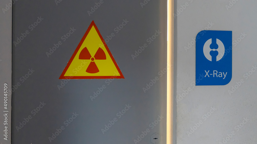 Xray warning signs posted on locked door and wall. Radioactive sign in ...