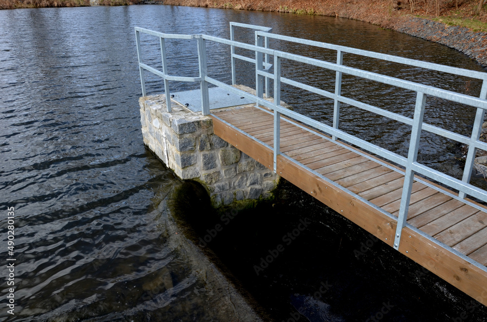 bridge over safety spillway of the dam. stone bridge with natural ...