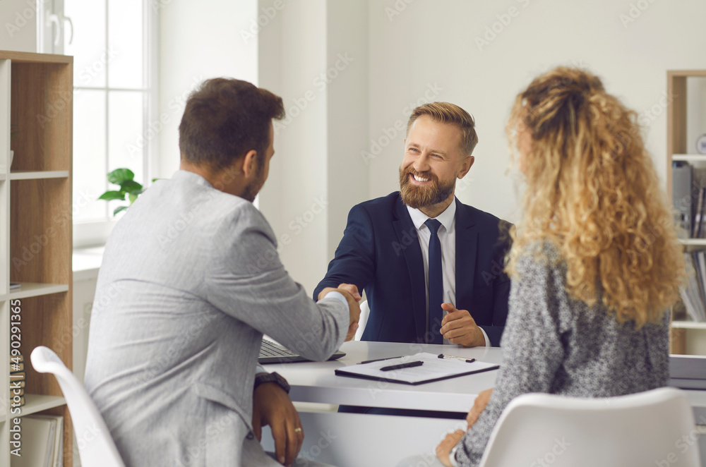Friendly lawyer, realtor or financial advisor shakes hands with his ...