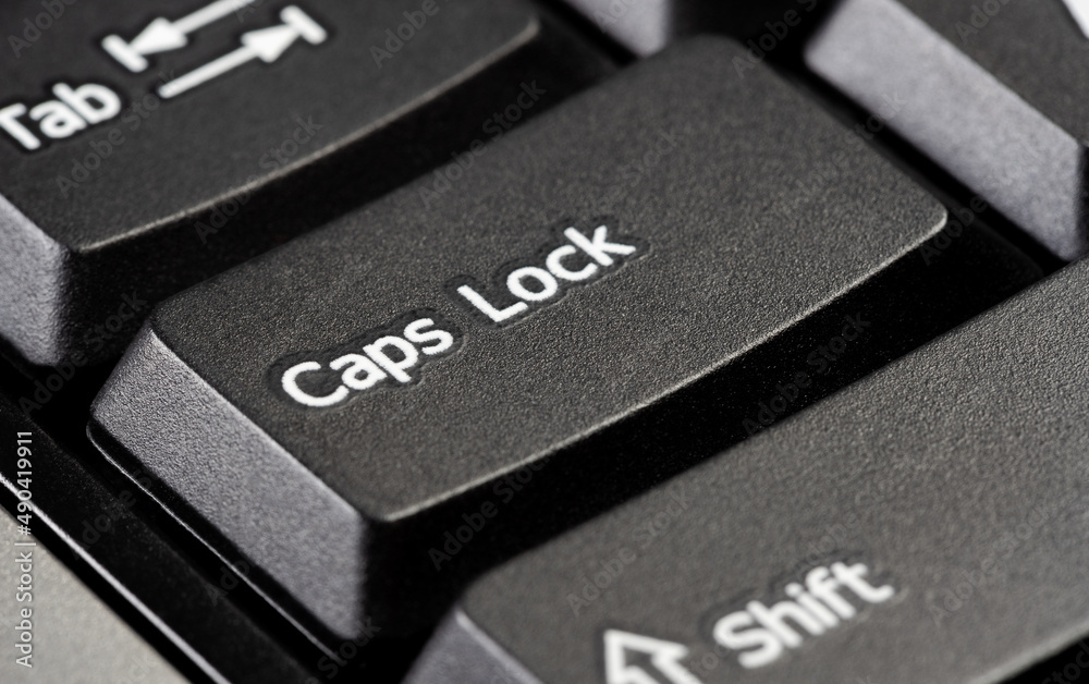 Single caps lock key on a simple black desktop PC computer keyboard ...