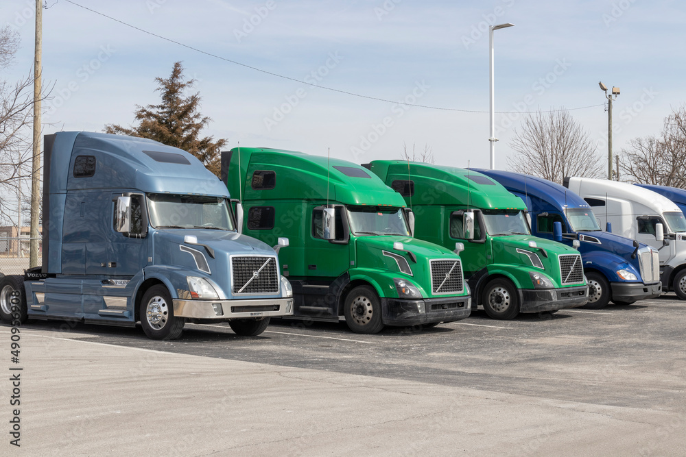 Volvo and Kenworth Semi Tractor Trailer Trucks display at a dealership ...