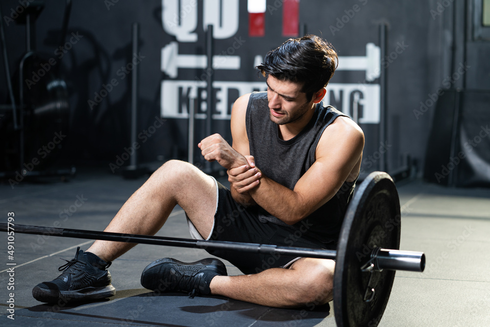 Young Caucasian men grab his arm and wrist and feeling painful while ...