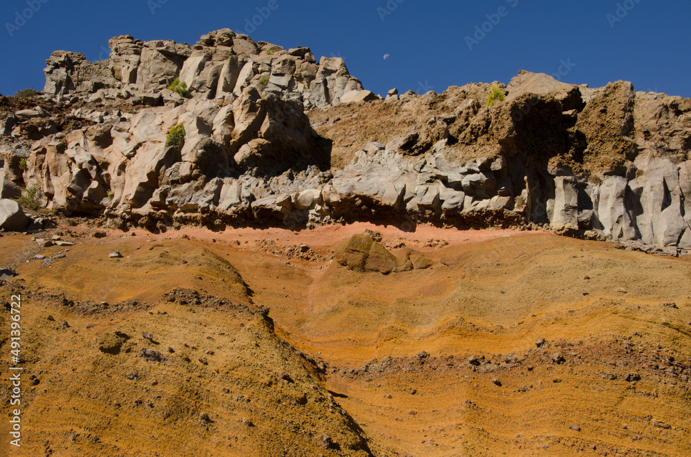 Cliff with volcanic tuff in its lower part and basaltic rock in the ...
