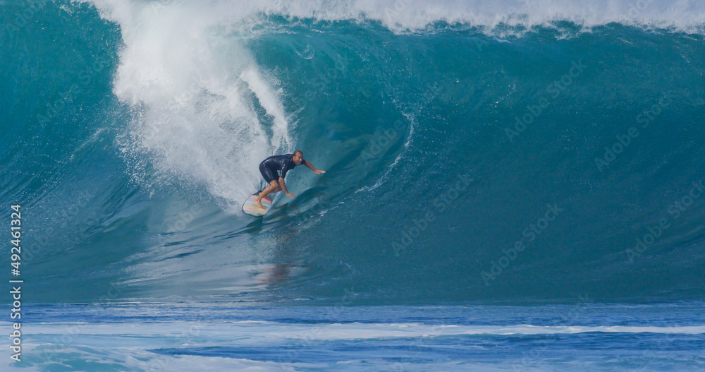 Surfer surfing big ocean barrel tube wave at Pipeline in north shore of ...