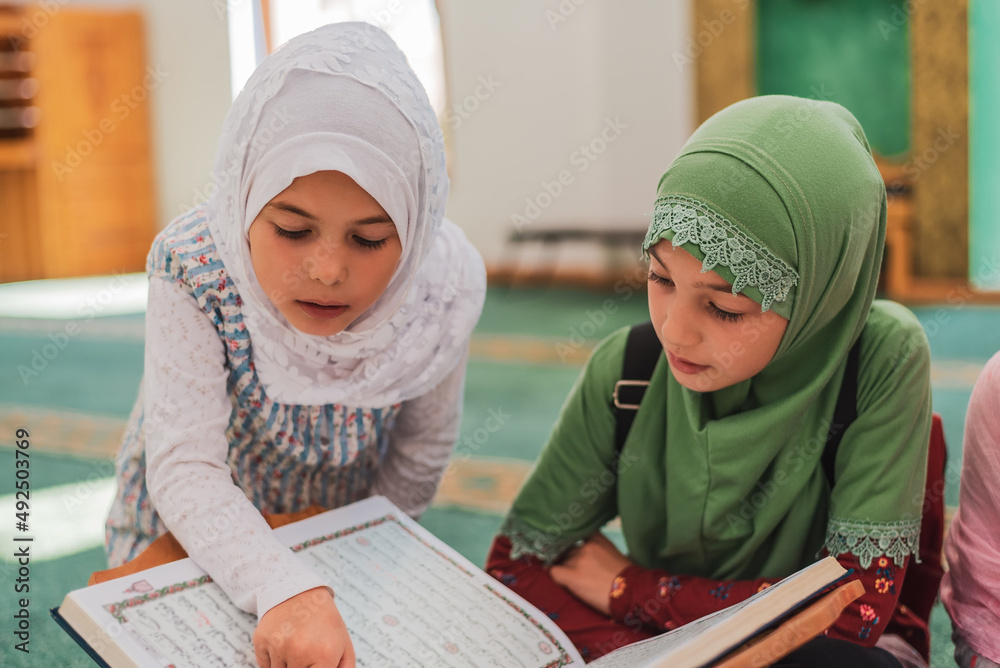 Foto de Stock Group of a children reading a holy book Quran in the ...