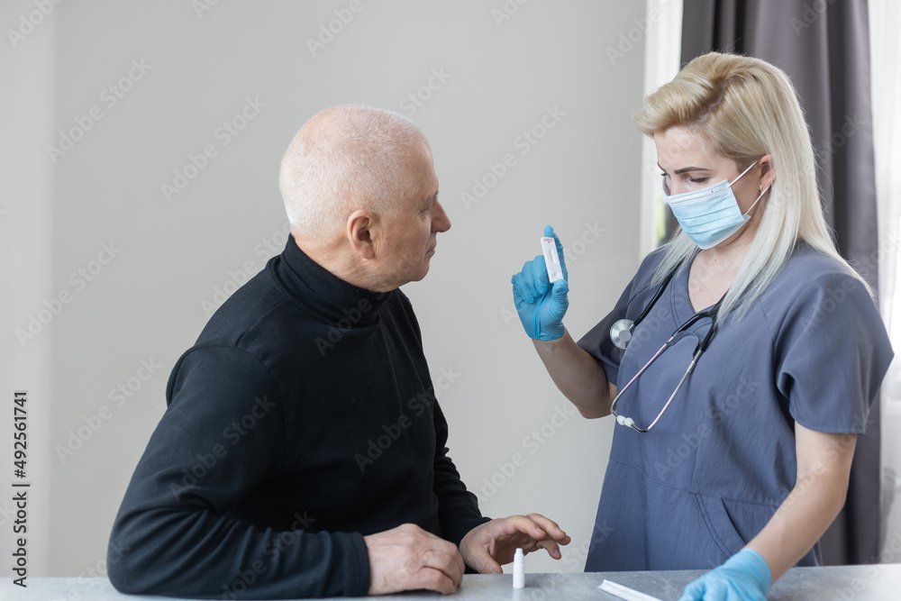 Close up of medical staff hands introducing the nasal swab to the ...