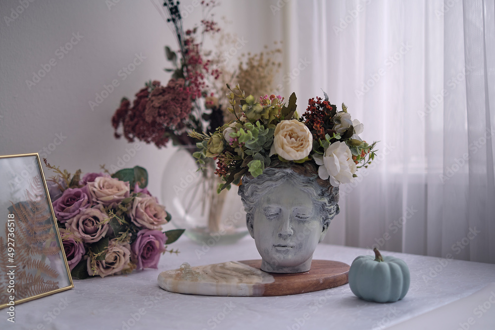 table by the window with interior details antique bust of Venus with ...