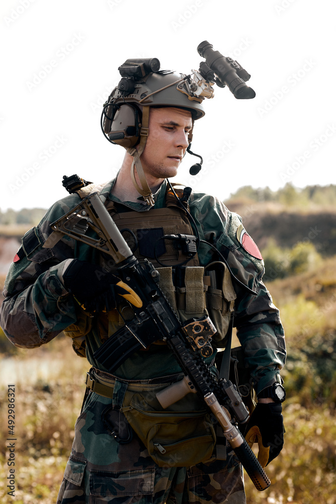 caucasian european army soldier outdoors, standing with assault rifle ...