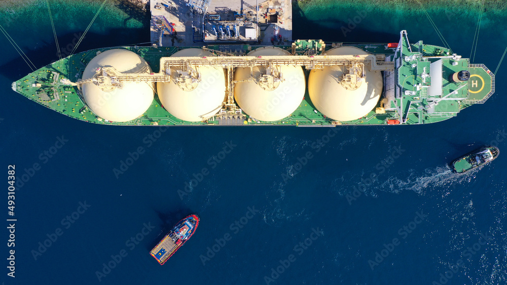 Aerial drone photo of LNG (Liquified Natural Gas) tanker anchored in small gas terminal island ...