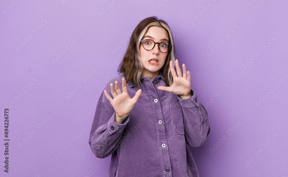 pretty caucasian woman feeling terrified, backing off and screaming in ...