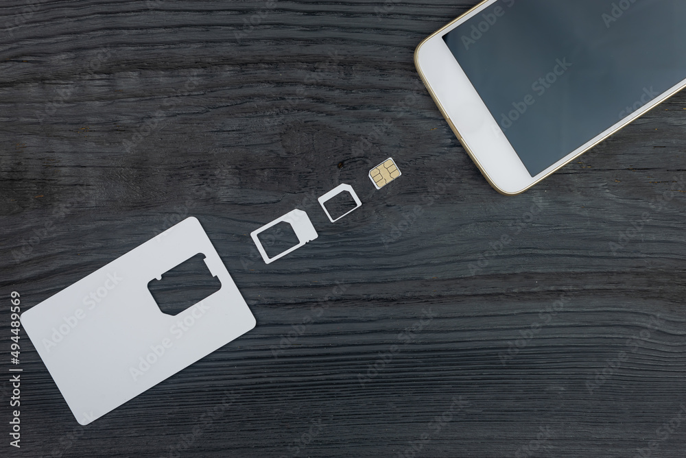 Foto SIM card, micro, mini, nano and smartphone. Concept: installing a ...