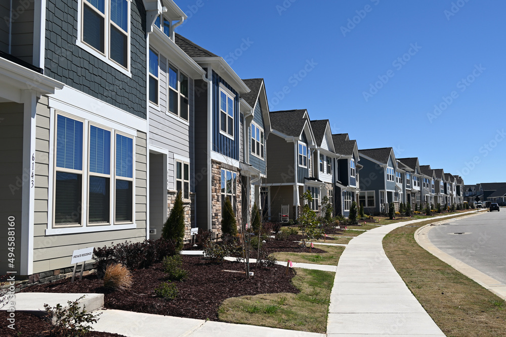 New tract homes stretch off into the distance in a planned community ...