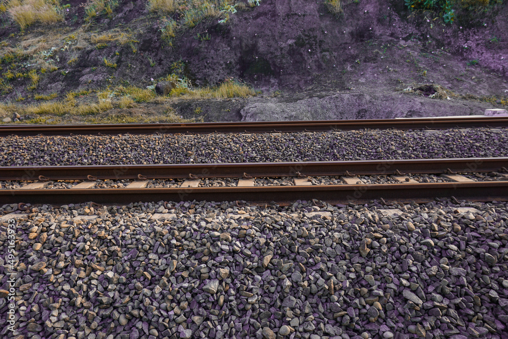 The railroad tracks pass through the grooved bearings buried under the ...