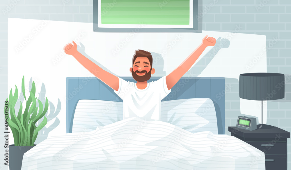 Happy man woke up and stretches in bed. Good morning. Awakening. Wake ...
