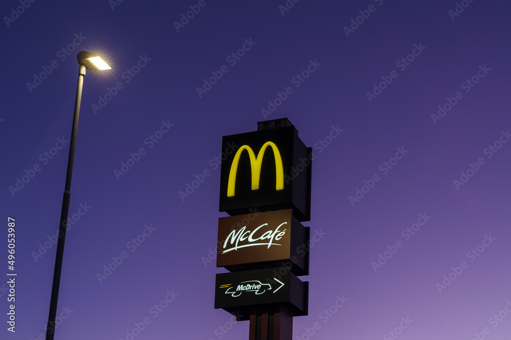 McDonald's and McCafe logos outside fast-food hamburger restaurant at ...