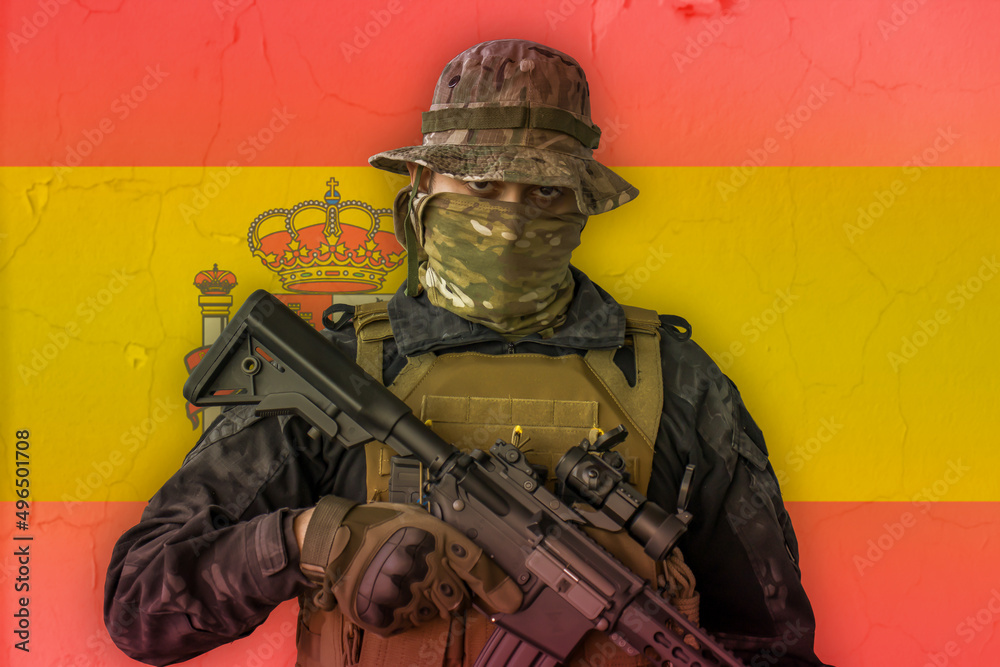 Angry spanish soldier armed with a rifle with spain flag as background ...